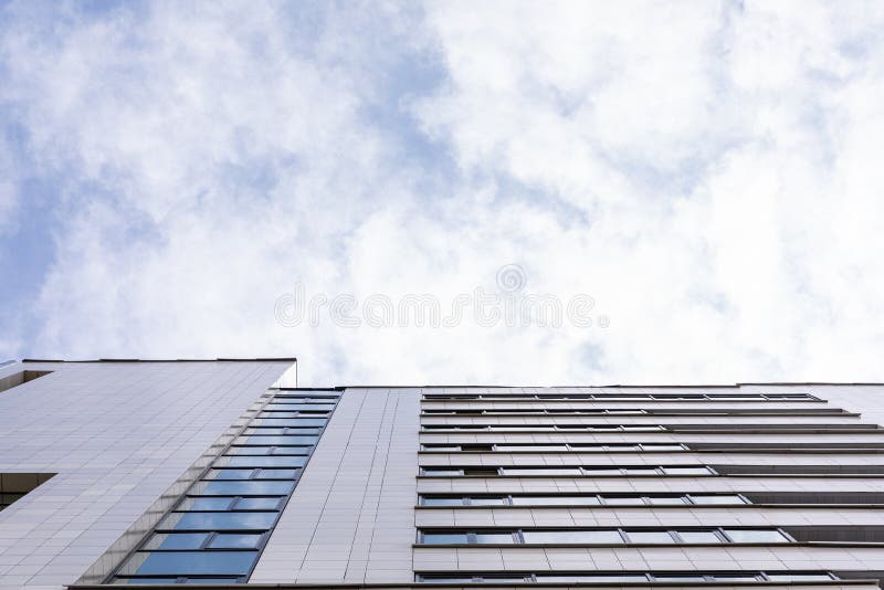 Ground View of Tall Building with Balconies and Tiled Facade. Stock ...
