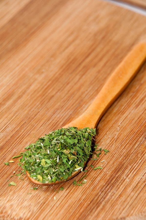 Grounded Parsley on the Wooden Spoon Stock Photo - Image of cilantro ...