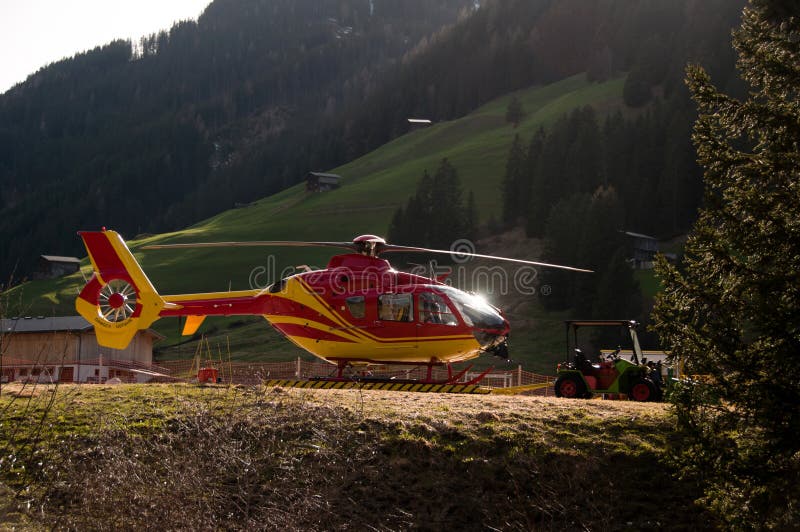 Grounded Yellow and Red Helicopter at Hangar Stock Photo - Image of ...