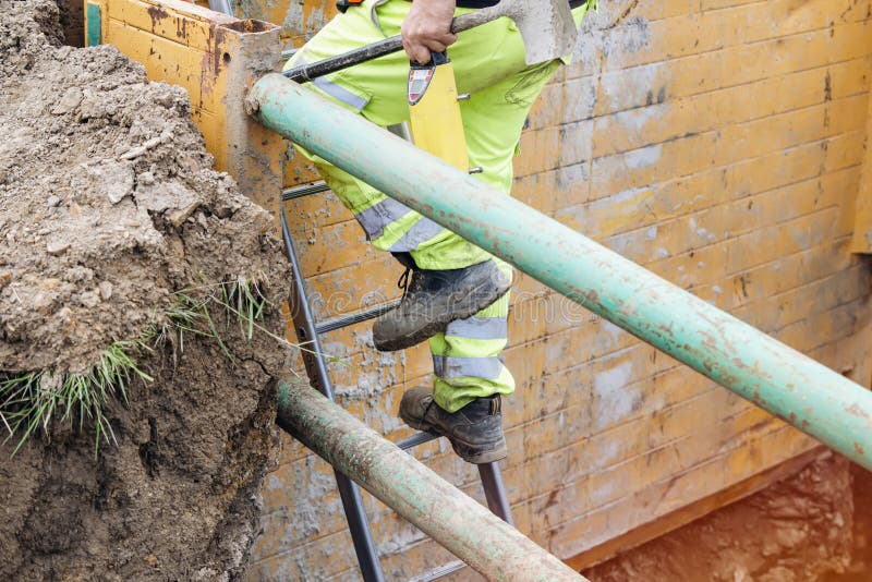 Groundworker Builder Using Steps Ladder To Get Out of Deep Drainage ...