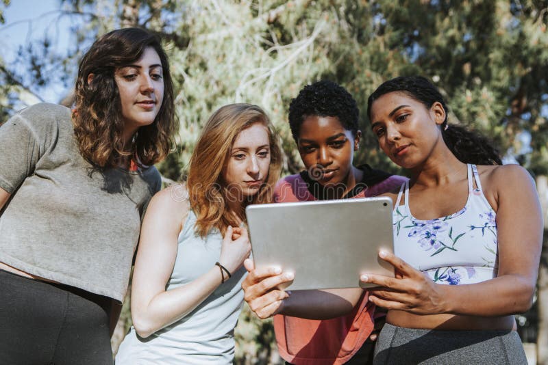 Group of Active Women Looking at a Digital Tablet Stock Photo - Image ...