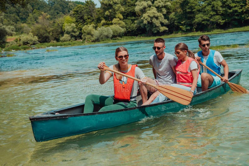 Group Adventurous Explorer Friends are Canoeing in a Wild River Stock ...
