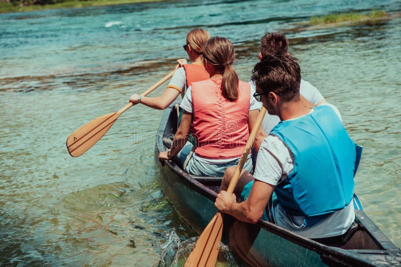Group Adventurous Explorer Friends are Canoeing in a Wild River Stock ...