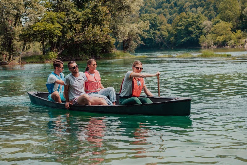 Group Adventurous Explorer Friends are Canoeing in a Wild River Stock ...