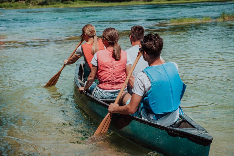 Group Adventurous Explorer Friends are Canoeing in a Wild River Stock ...