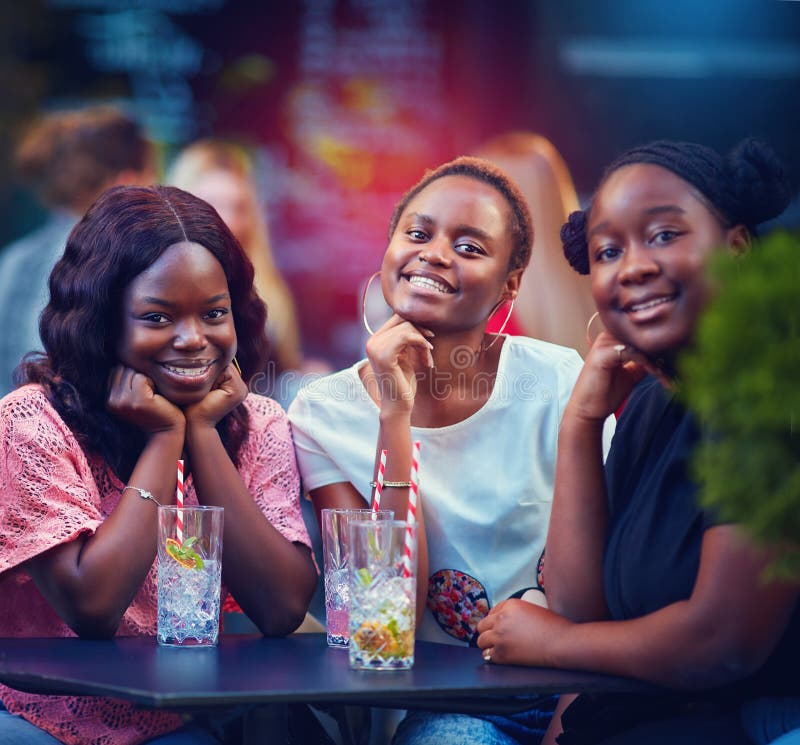 A Group Of African American Friends Having Fun At The Street Restaurant