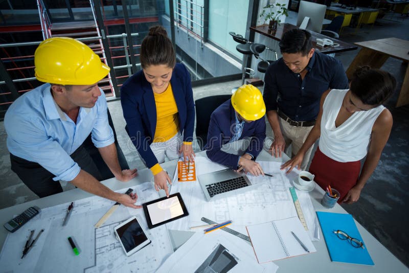 Group of Architects Discussing Blueprint Together Stock Image - Image ...