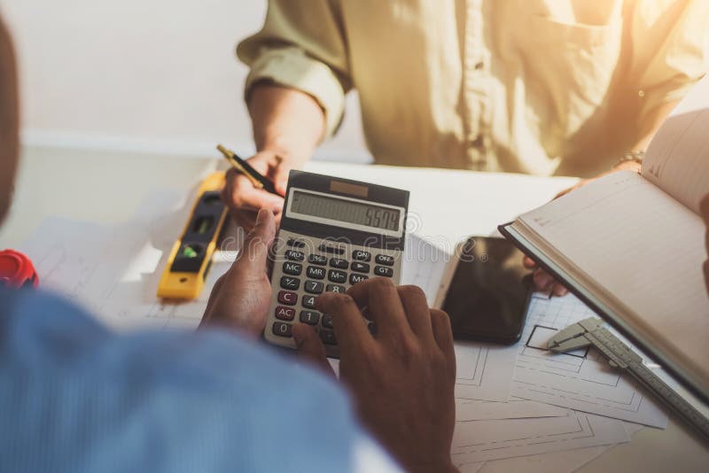 Group of Architects Discussing and Useing Calculator about Calculate ...