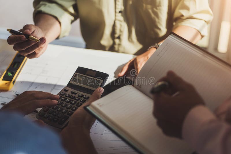 Group of Architects Discussing and Useing Calculator about Calculate ...