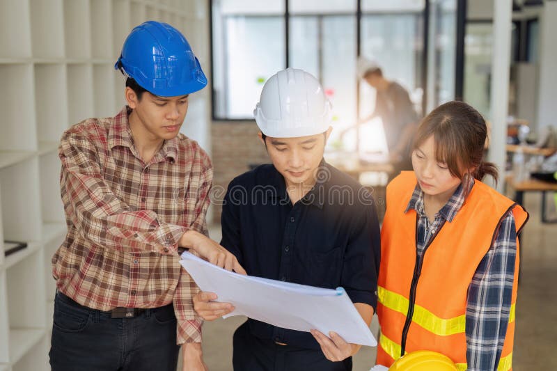 Group of Architects and Engineers Discuss about Construction Blueprint ...
