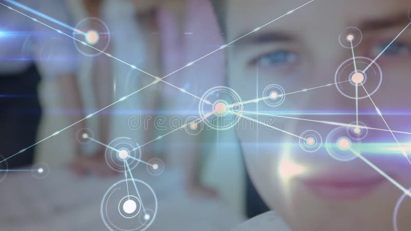 A Group of Architects are Looking Over Blueprints while One Smiles at ...