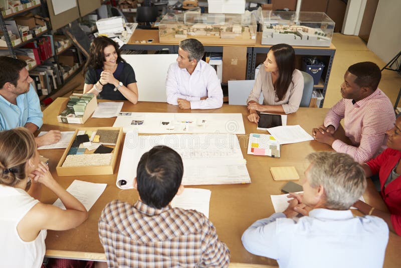 Group of Architects Sitting Around Table Having Meeting Stock Image ...