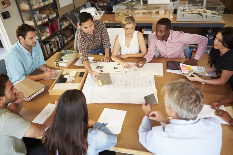 Group of Architects Sitting Around Table Having Meeting Stock Photo ...
