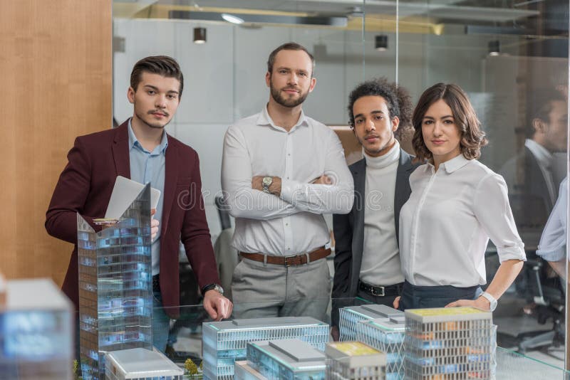 Group of Architects Standing Next To Building Models Stock Image ...