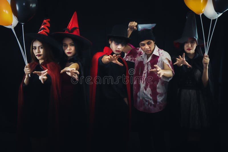 Group Of Asian Friends In Spooky Costume Having Fun And Drink Cocktails