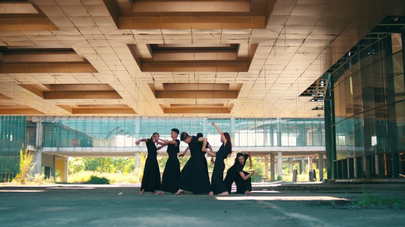 A Group of Asian Men in Black Costumes Dance a Contemporary Dance Under ...