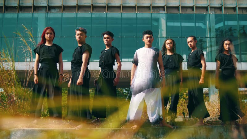 A Group of Asian Men Standing in Front of an Old Building and Enjoying ...