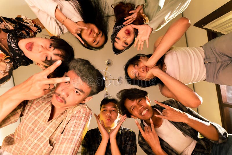 A Group of Asian People are Looking Down Simultaneously with Serious ...