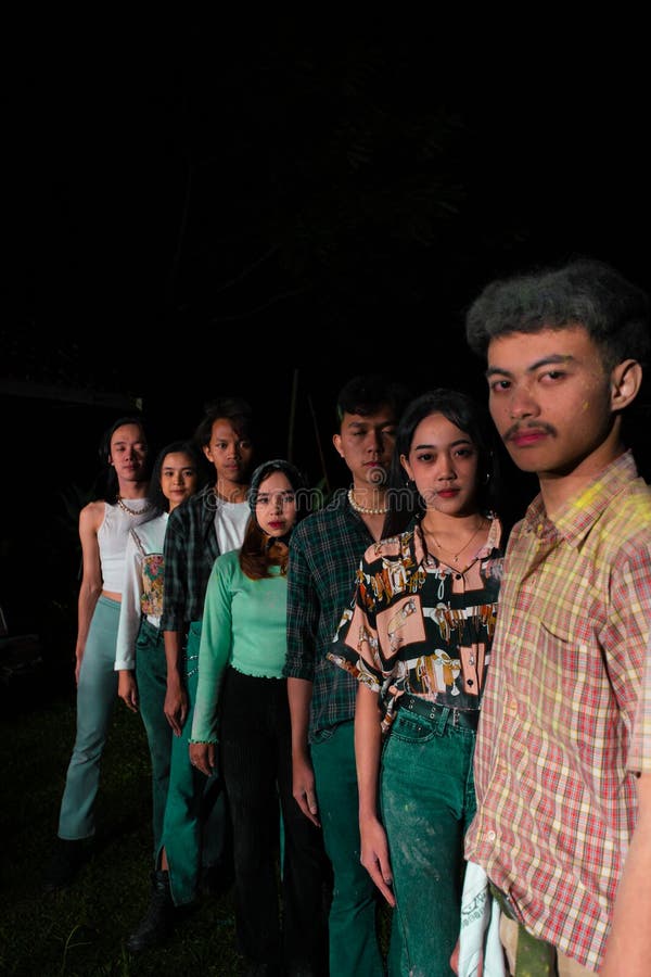 A Group of Asian People Standing and Lining Up Looking at the Camera ...