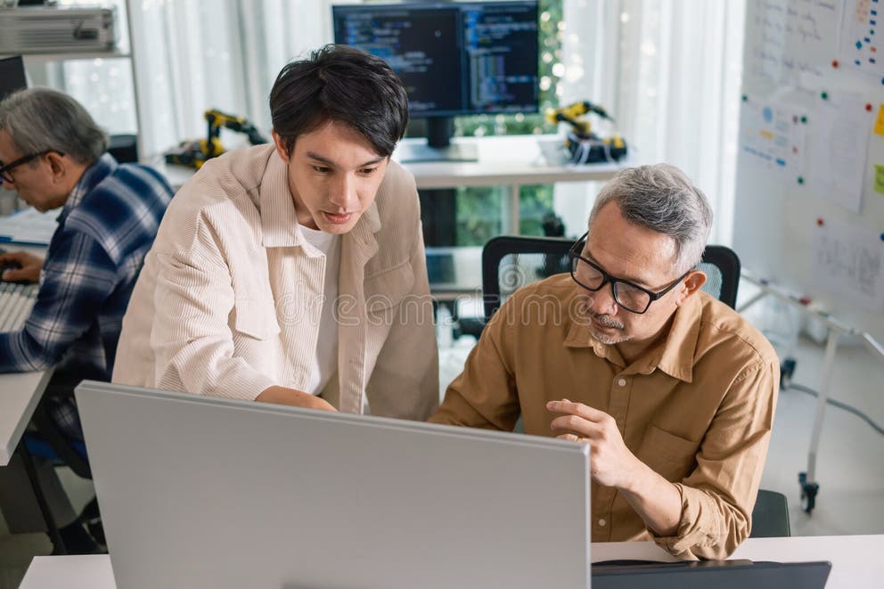 Group of Asian Senior in a Collaborative Software Development Analyzing ...