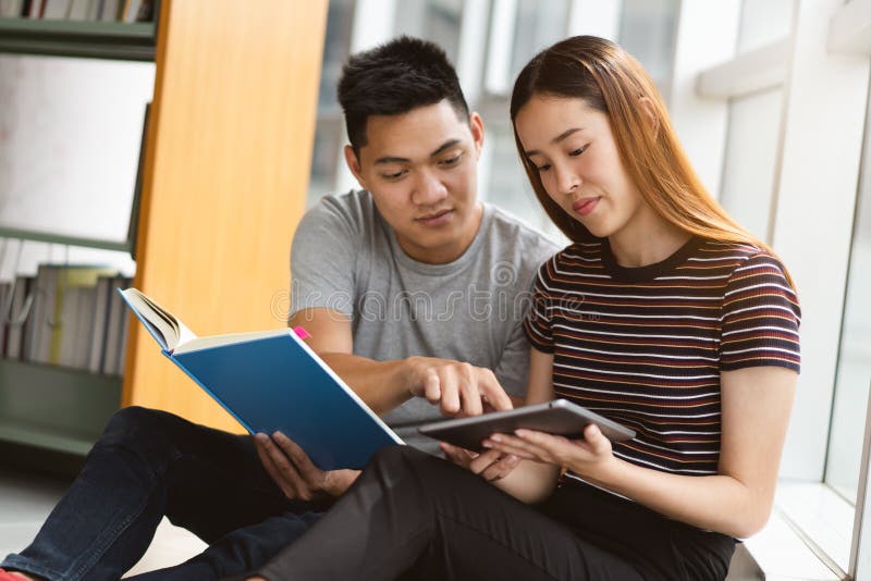 Two Asian Students Researching for Project in Library Stock Photo ...