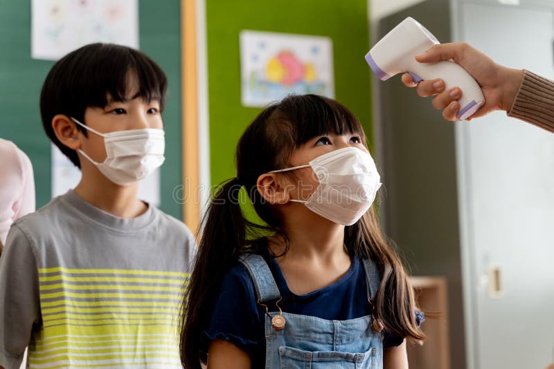 Group of Asian Students in School Building Checked and Scanned for ...