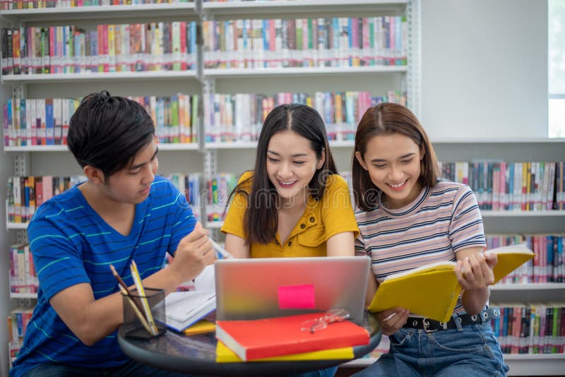 Group Asian Students Smile and Reading Book and Using Notebook for ...