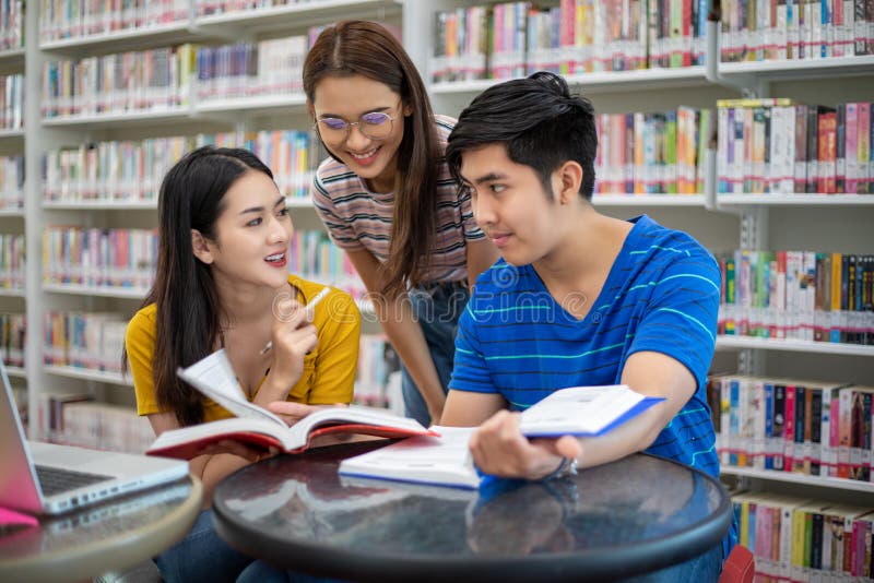 Group Asian Students Smile and Reading Book and Using Notebook for ...