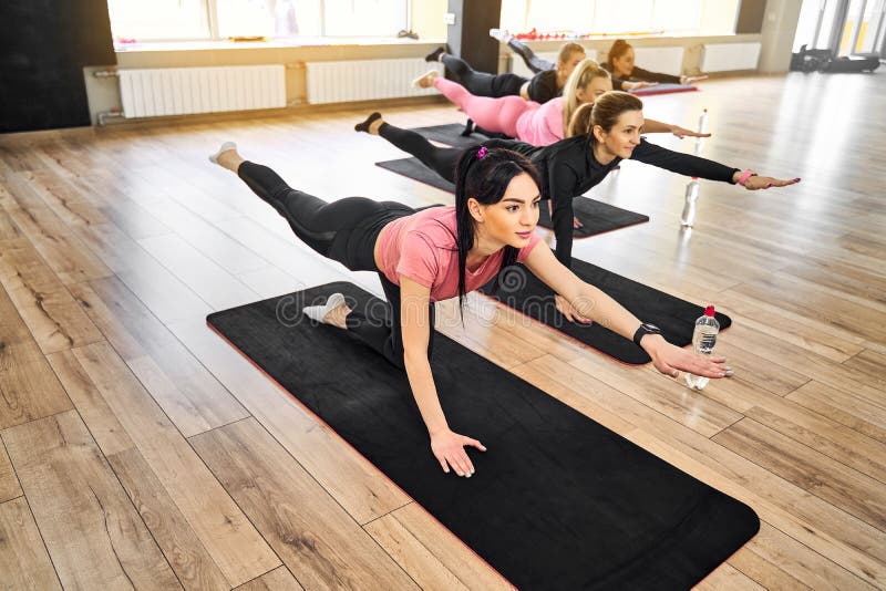 Group of Athletic Women Doing Push-UPS on the Floor and Stretching ...