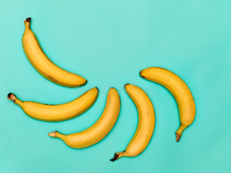 The Group of Bananas Against Blue Background Stock Photo - Image of ...