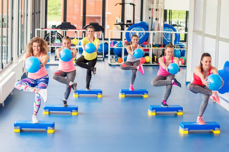 Group of Beautiful Young Women Working Out on Blue Stepper. Stock Photo ...
