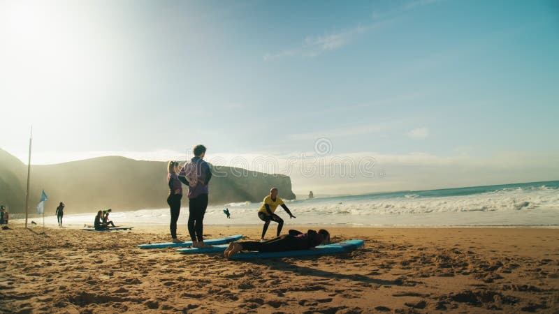 Group of Beginner Surfers Learn To Surf on Beach Stock Footage - Video ...