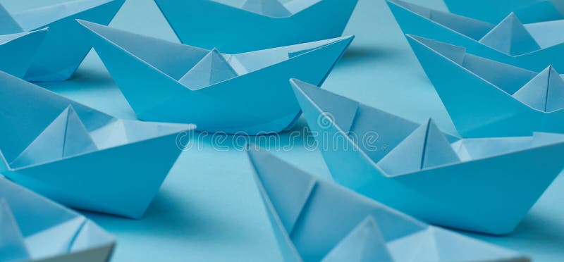 A Group of Blue Paper Boats on a Blue Background. the Concept of a ...