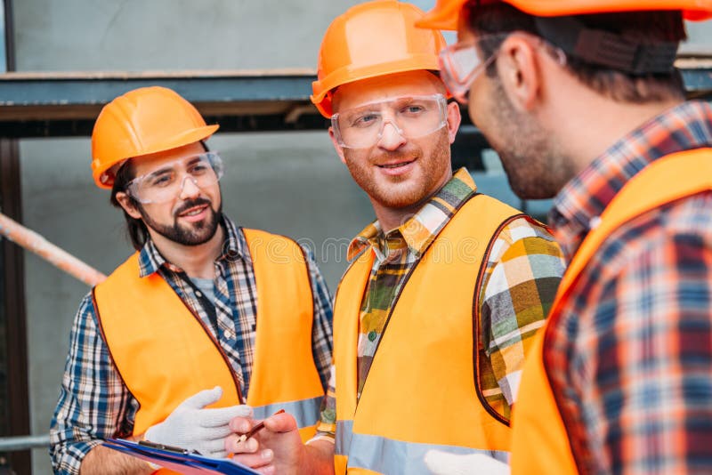 Group of Builders in Hard Hats and Reflective Vests Stock Photo - Image ...