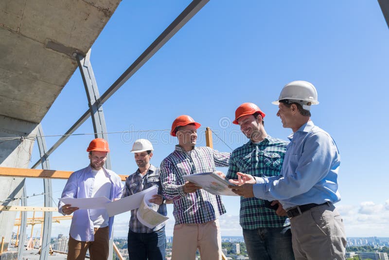Group of Builders on Construction Site Building Team of Apprentices ...