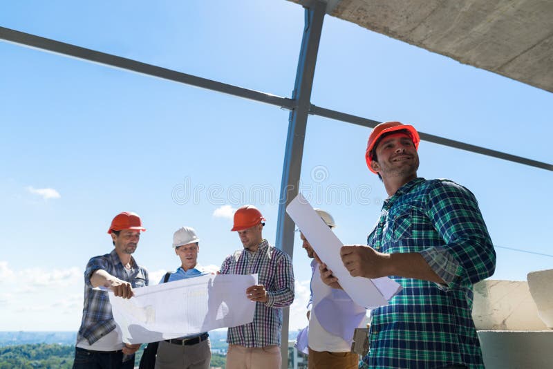 Group of Builders in Hardhat Hold Plan Discussing Project on ...