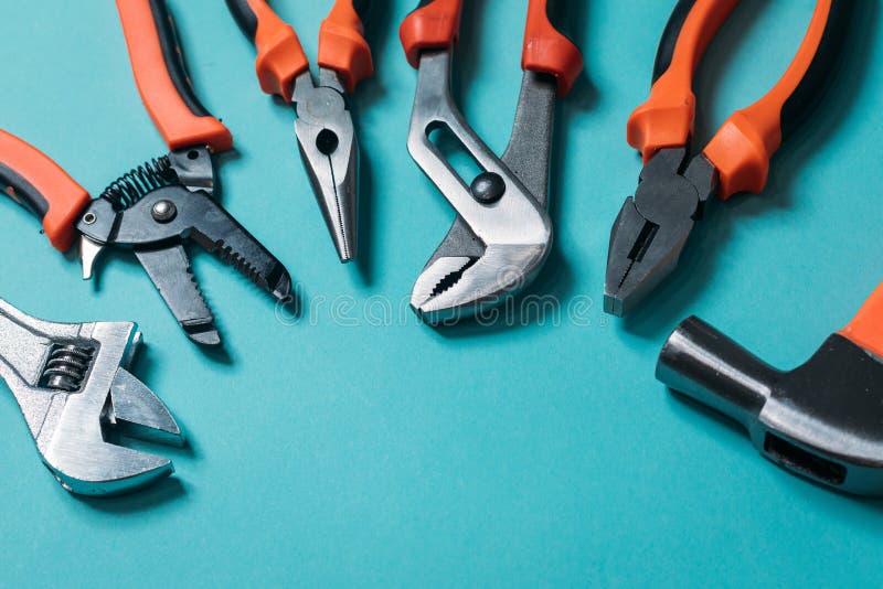 Group Bunch of Tools with Orange Handles on a Blue Background Close ...