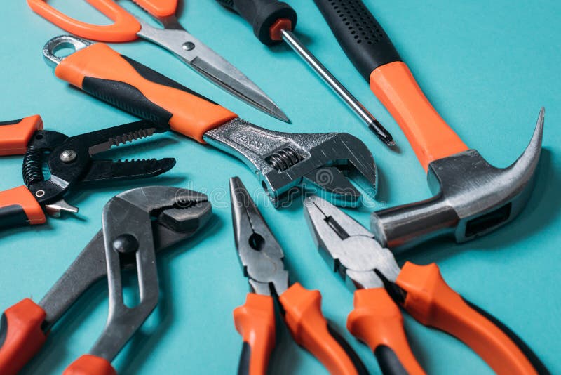 Group Bunch of Tools with Orange Handles on a Blue Background Close ...