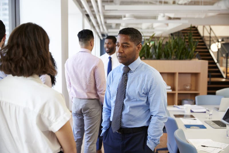 Group of Business Colleagues Chatting in Office after Meeting Stock ...