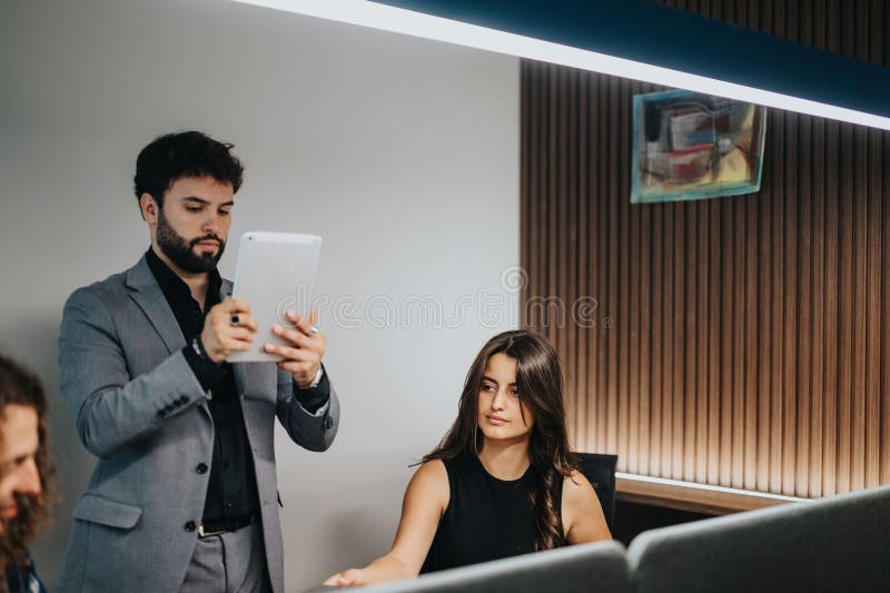 Group of Business Colleagues Collaborating on a Project in a Modern ...