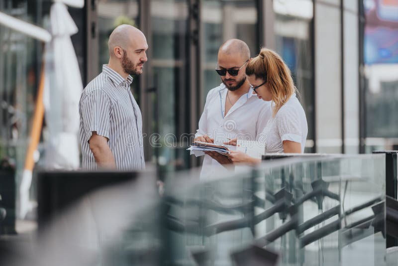 Group of Business Colleagues Discussing Work Outdoors in a Modern Urban ...