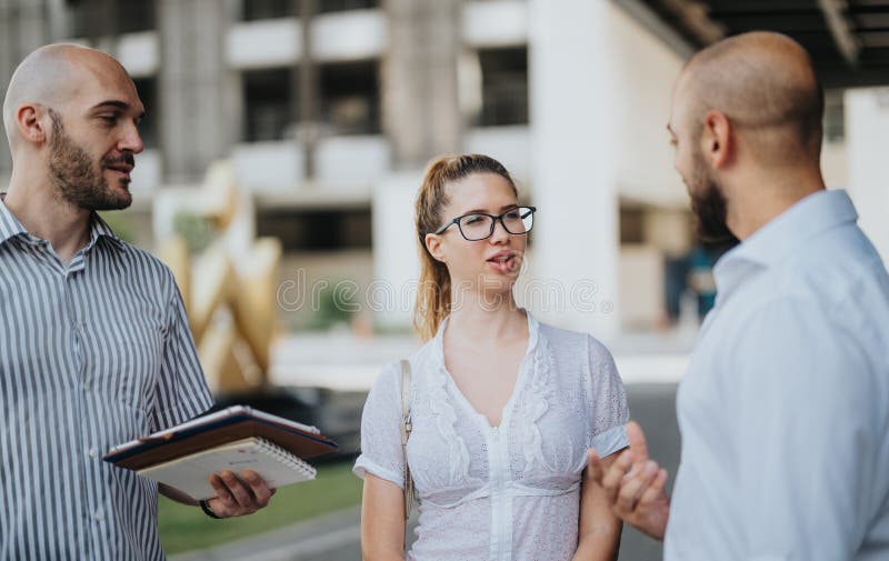 Group of Business Colleagues Having an Outdoor Conversation during a ...