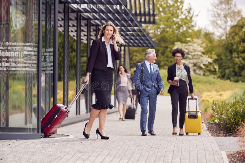 Group of Business Delegates with Luggage Arriving at Conference Hotel ...