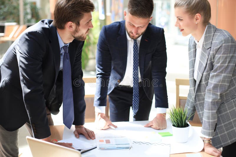 Group of Business Partners Discussing Ideas and Planning Work in Office ...
