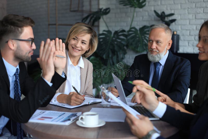 Group of Business Partners Discussing Ideas and Planning Work in Office ...