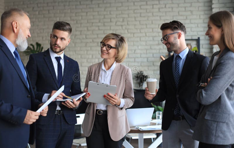 Group of Business Partners Discussing Ideas and Planning Work in Office ...