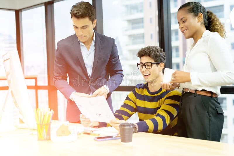 Group of Business Partners Discussing Together Documents and Ideas at ...
