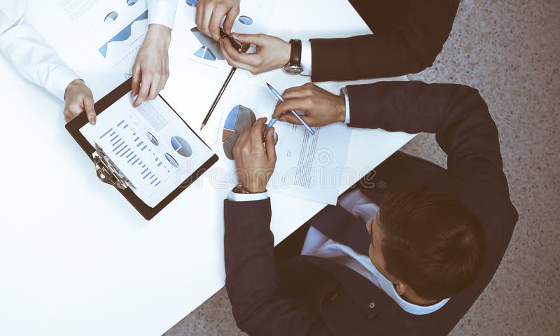 Group of Business People Analyzing Financial Documents, View from Above ... Group of Business People Analyzing Financial Documents, View from Above ...