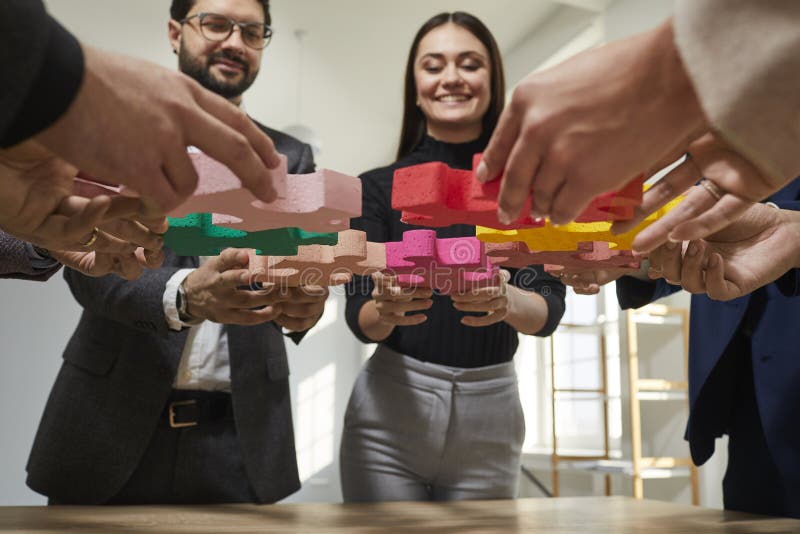 Group of Business People Assembling Jigsaw Puzzle at Office ...