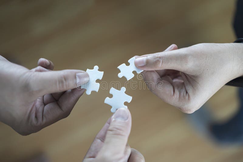 Group of Business People Assembling Jigsaw Puzzle and Represent Team ...